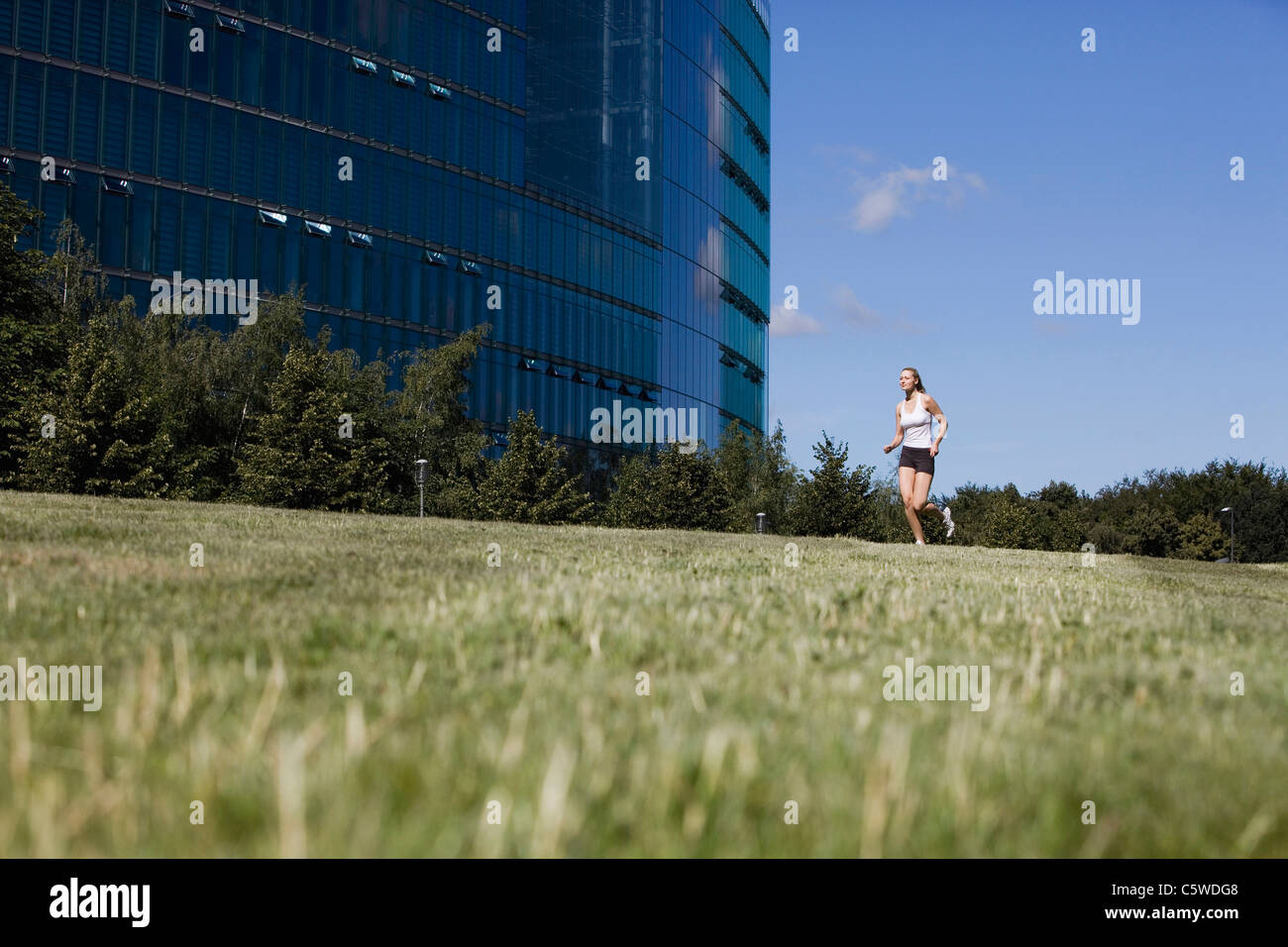 Germany, Berlin, Young woman jogging Stock Photo - Alamy