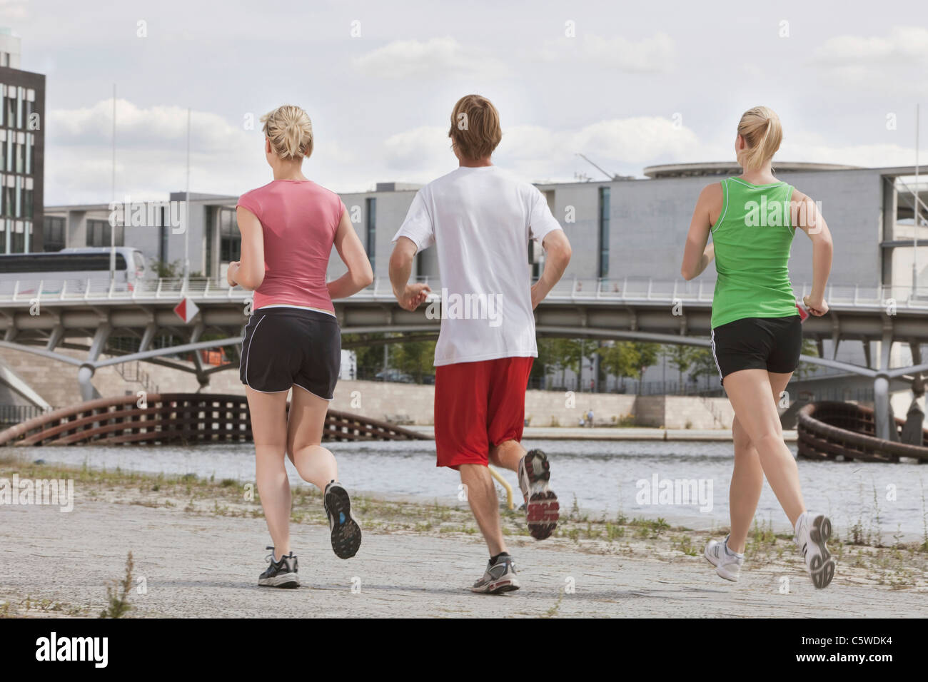 Germany, Berlin, Three person jogging in the city, rear view Stock ...
