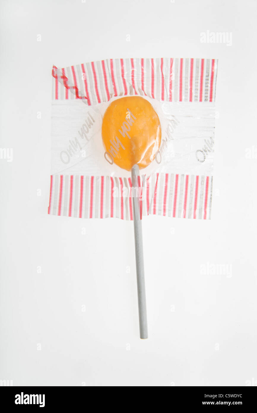 Close up of lollipop in wrapper against white background Stock Photo ...