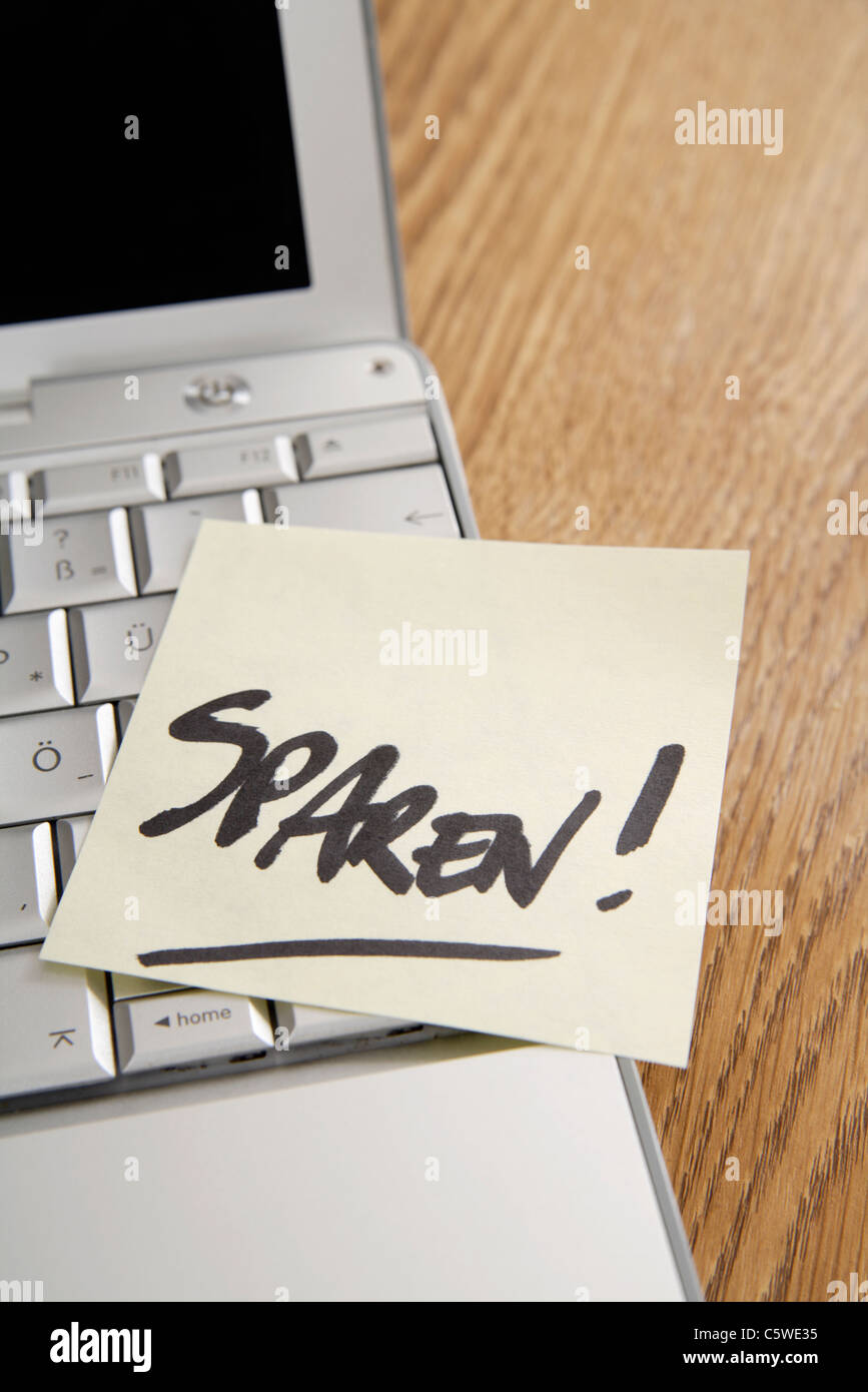Adhesive note on laptop saying "Saving Stock Photo - Alamy