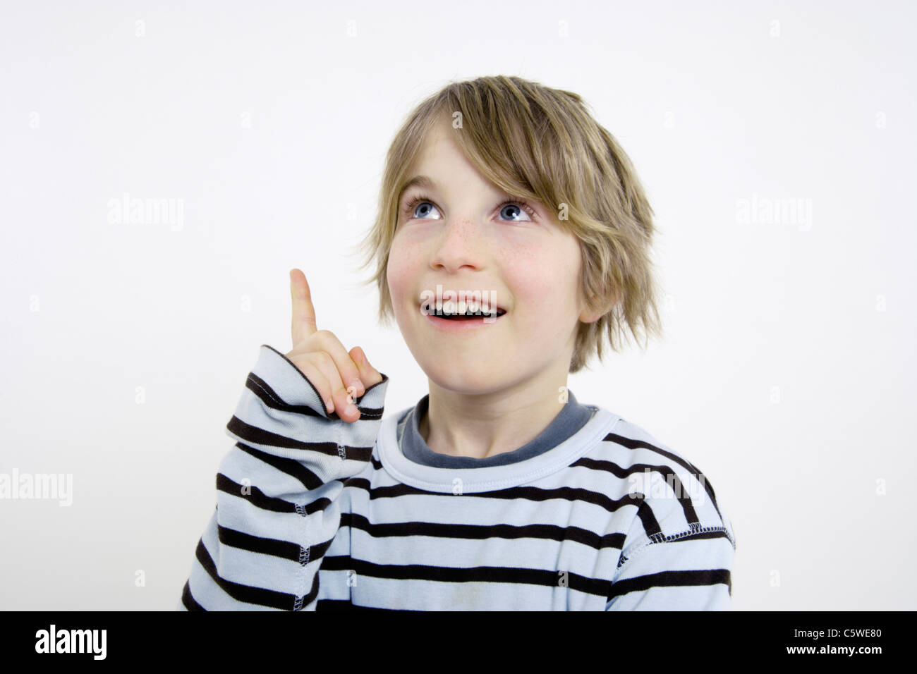 Boy (10-11) pointing and looking upwards, portrait Stock Photo - Alamy