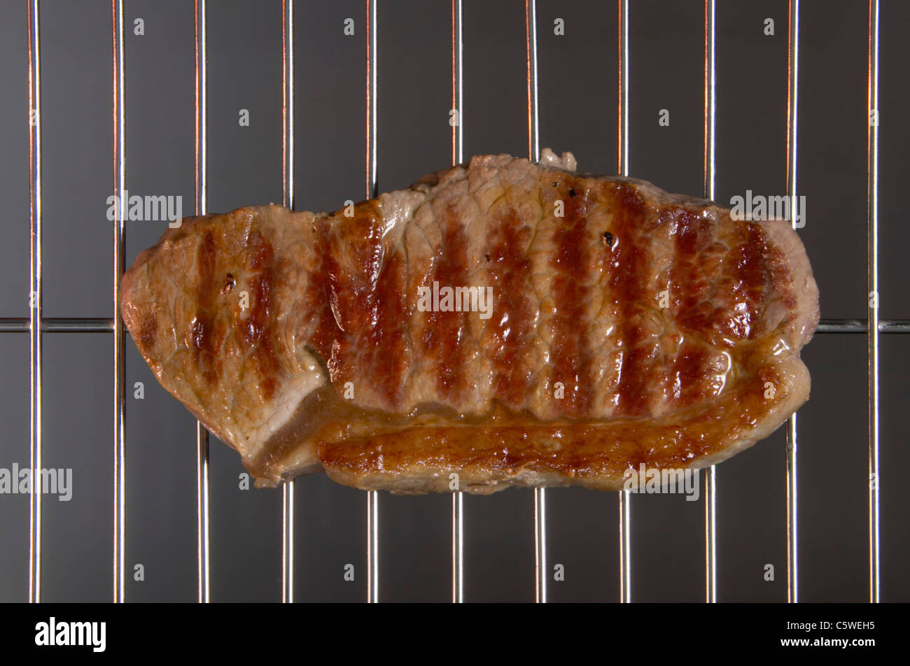 Grilled rumpsteak on grill, elevated view Stock Photo - Alamy