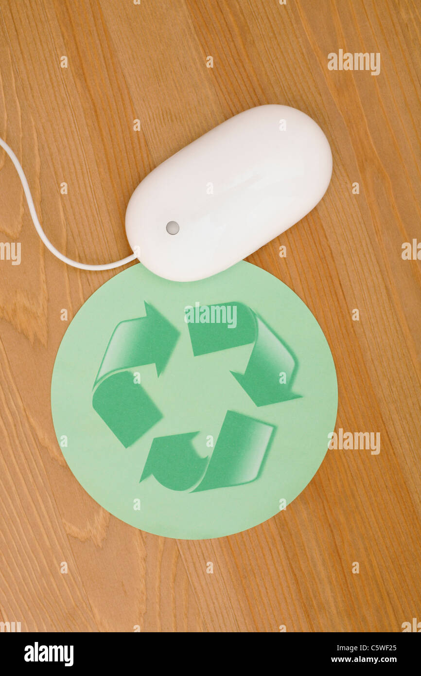 Computer mouse next to mouse pad with recycling symbol, elevated view ...