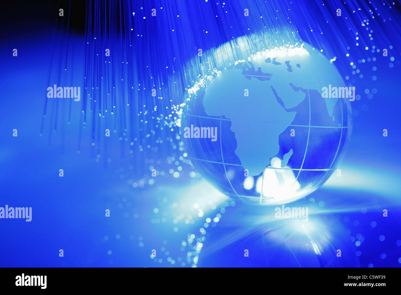 Illuminated blurred blue fiber light with blue glass globe Stock Photo ...