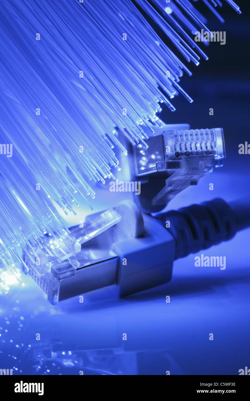 Blue fiber light with ethernet cable, close-up Stock Photo - Alamy