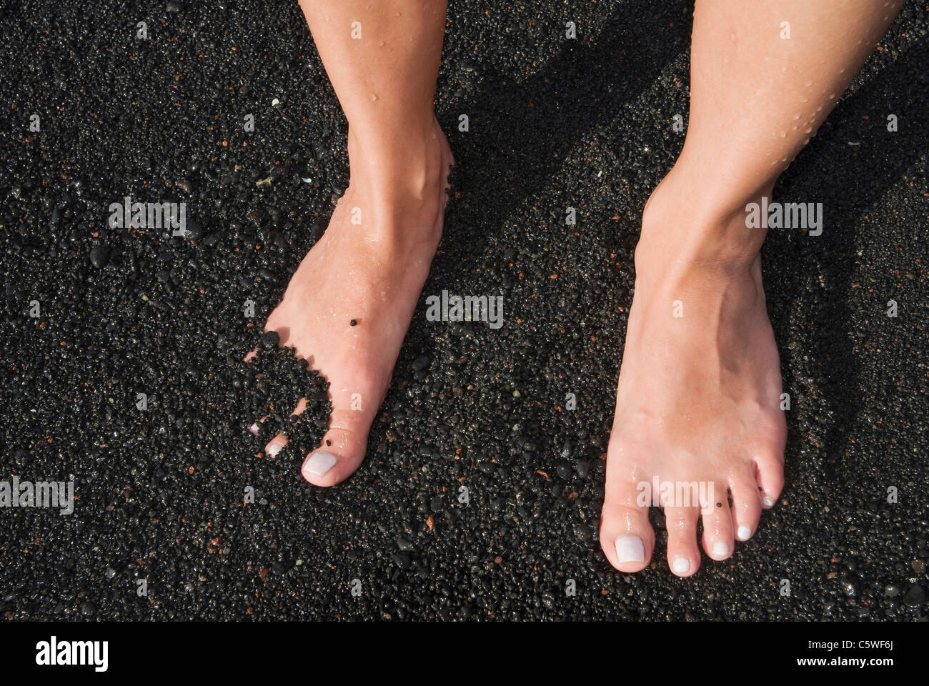 Spain, Lanzarote, Feet on lava sand, elevated view Stock Photo - Alamy