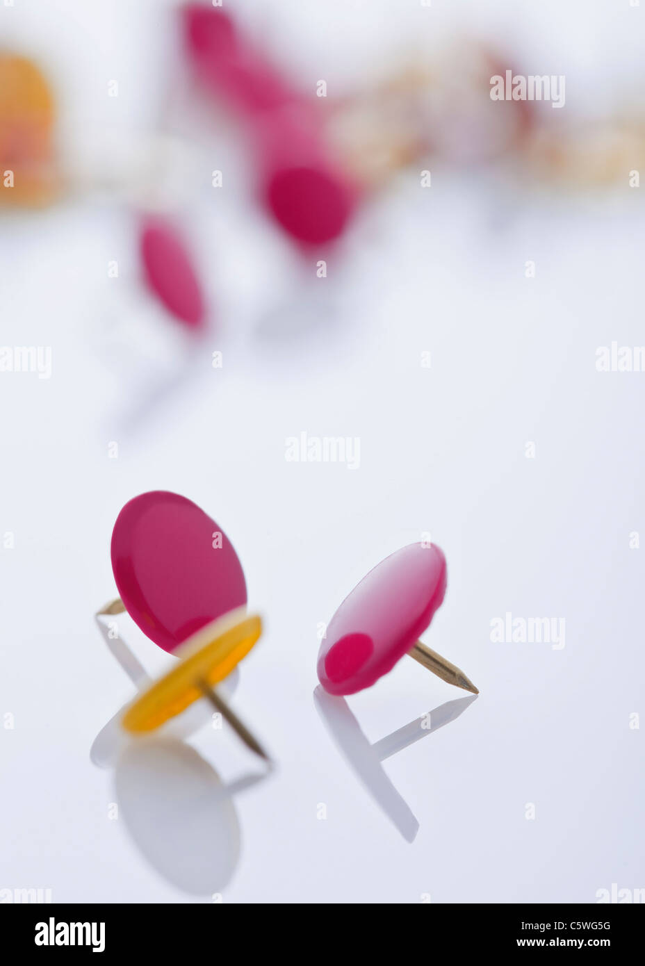 Red and yellow pins on white background Stock Photo - Alamy
