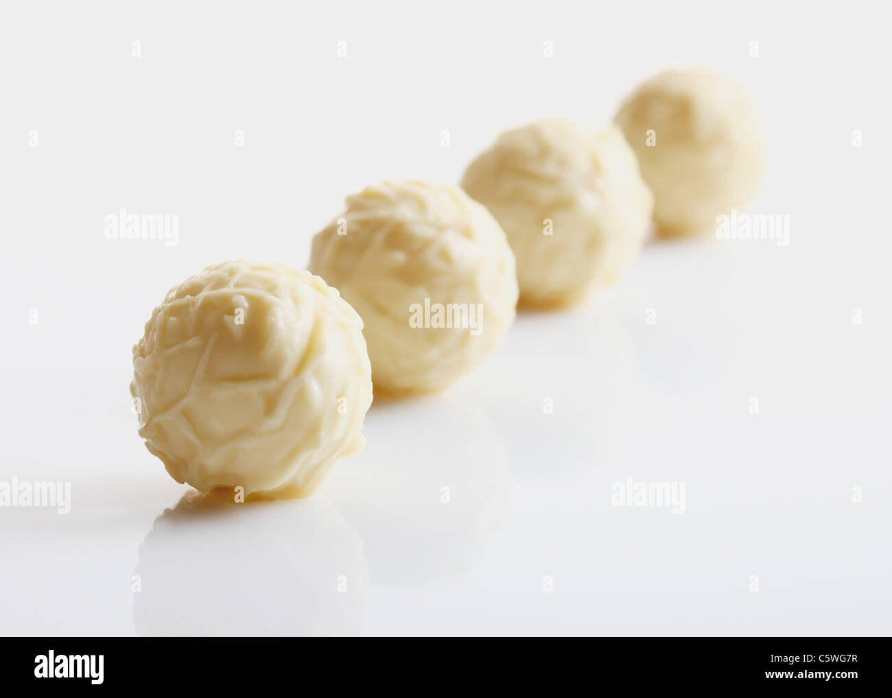 White truffle chocolate on white background Stock Photo - Alamy
