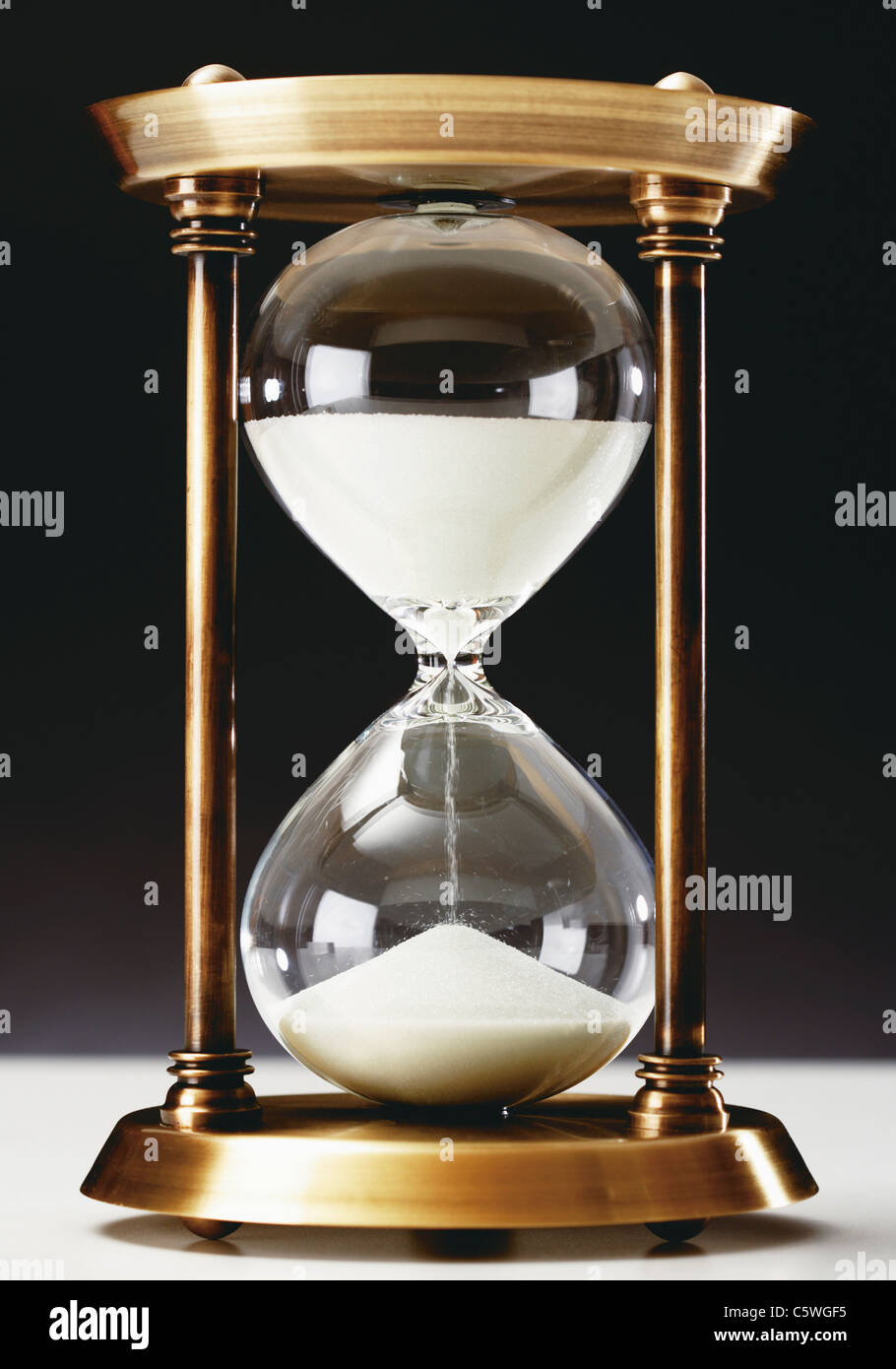 Hourglass on black background, close up Stock Photo - Alamy