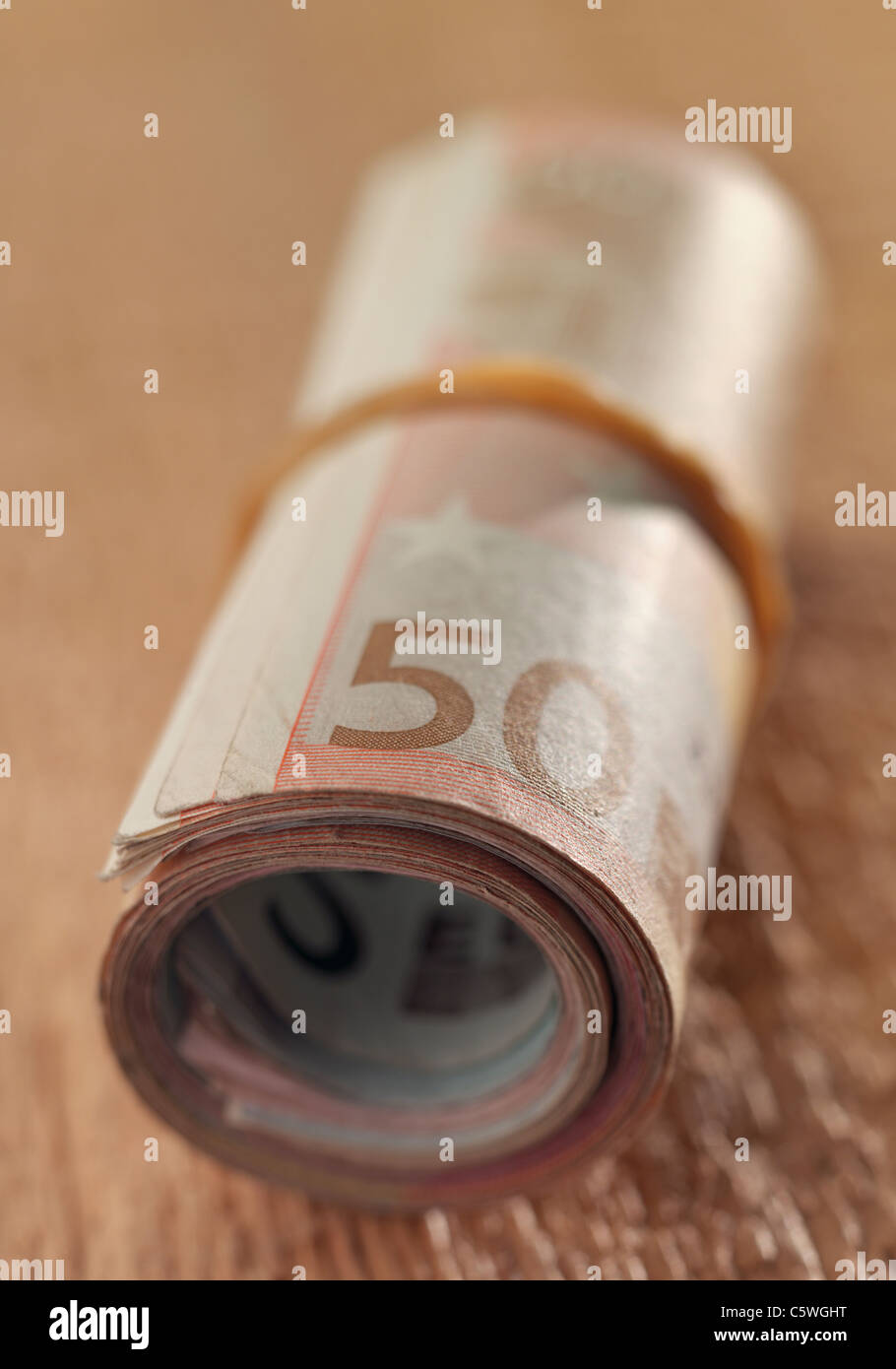 Close up of euro notes rolled up with rubberband Stock Photo - Alamy