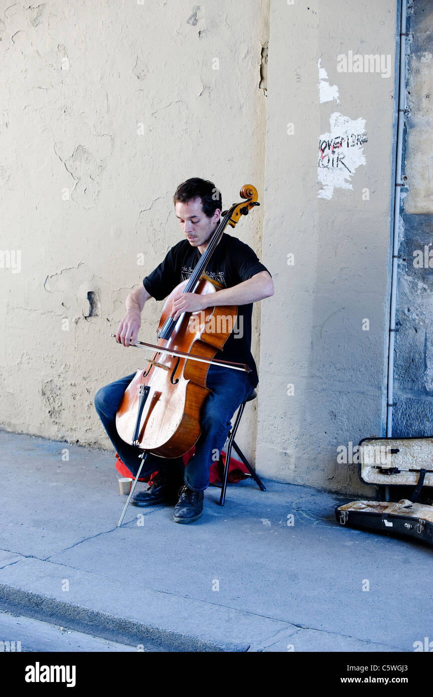 Cello playing busker in Paris, France Stock Photo - Alamy