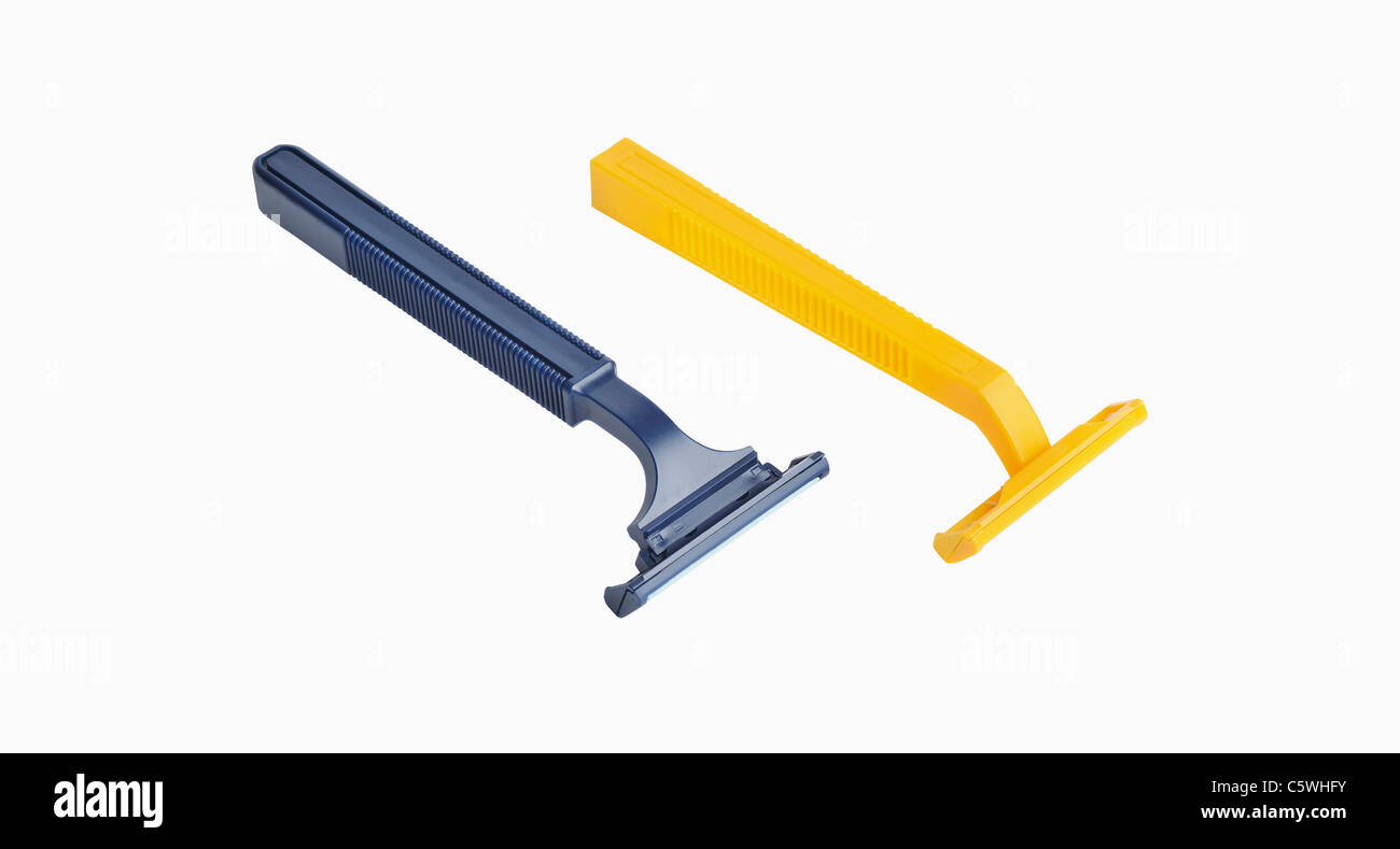 Two disposable razors against white background, close up Stock Photo ...