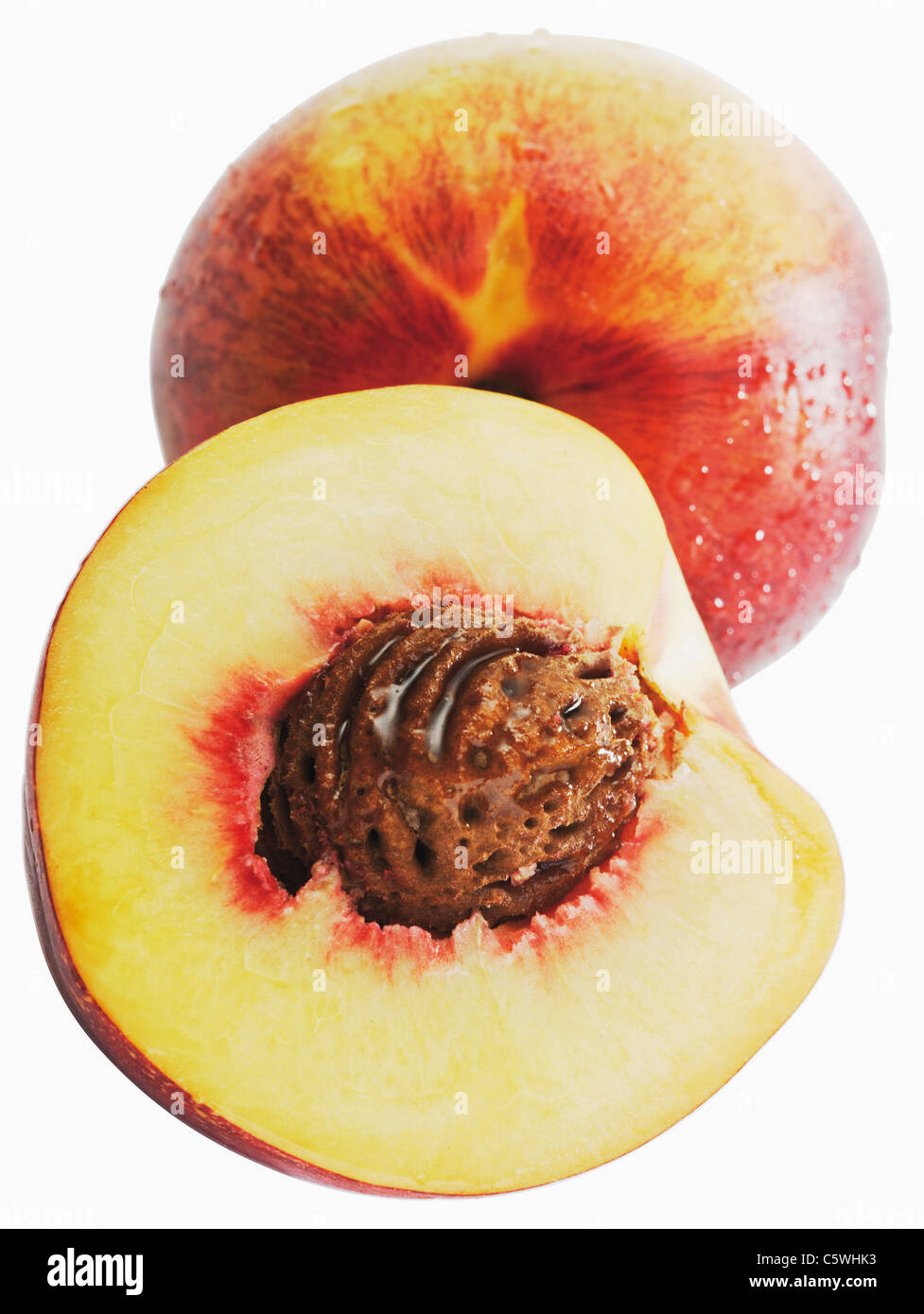 Peaches whole and halved against white background, close up Stock Photo ...