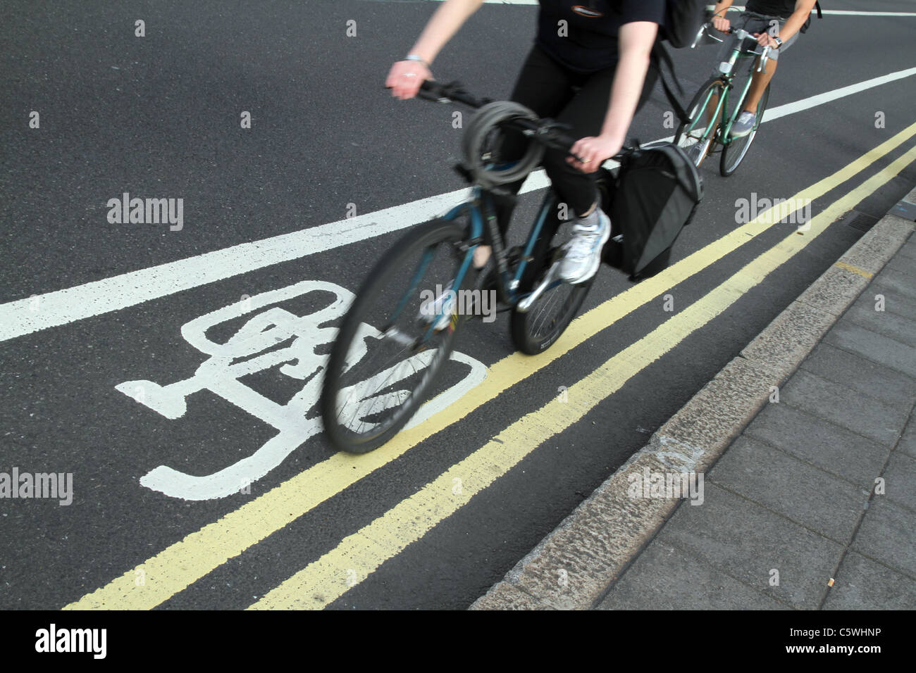 UK. Cyclists on a cycle lane in London Stock Photo - Alamy
