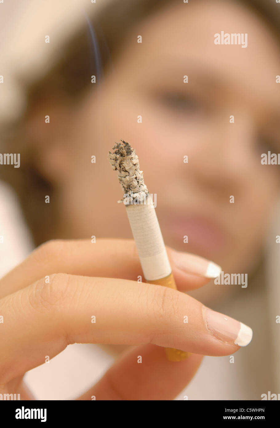 Close up of woman's finger holding burnt cigarette Stock Photo - Alamy