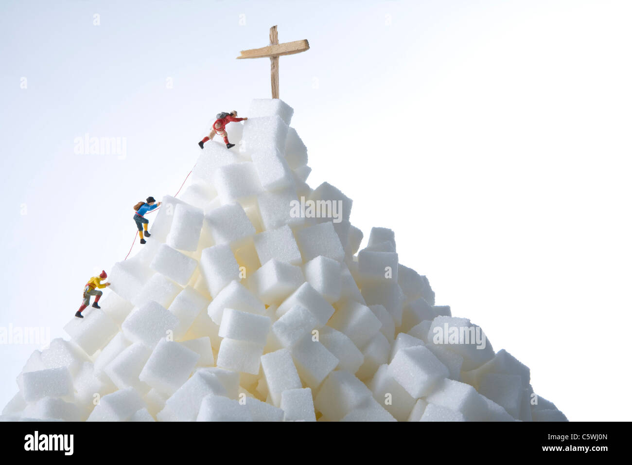 Plastic figurines climbing a mountain Stock Photo - Alamy