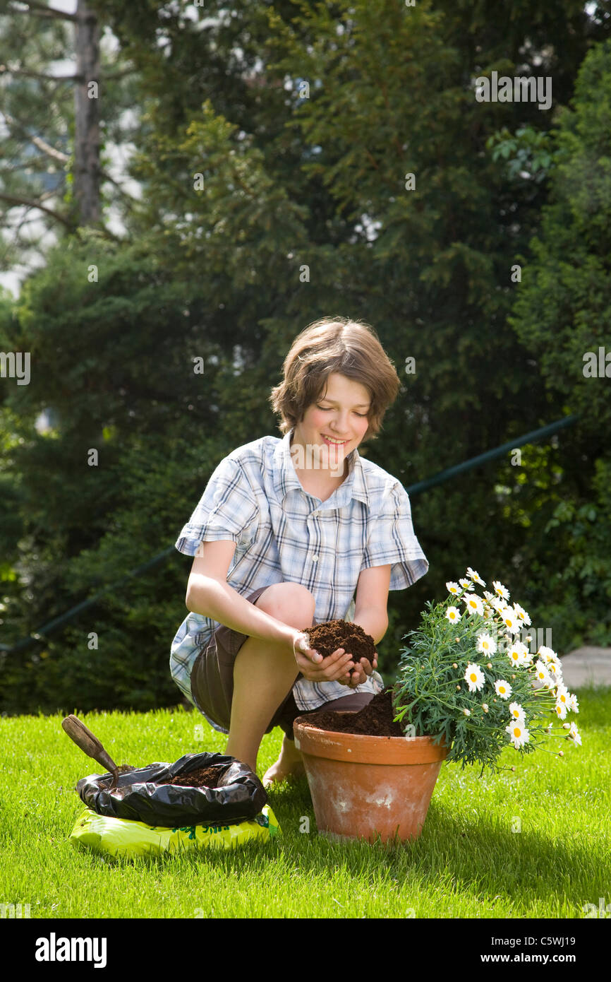 Germany, Baden-WÃ¼rttemberg, Stuttgart, Boy (12-13) potting plant Stock ...