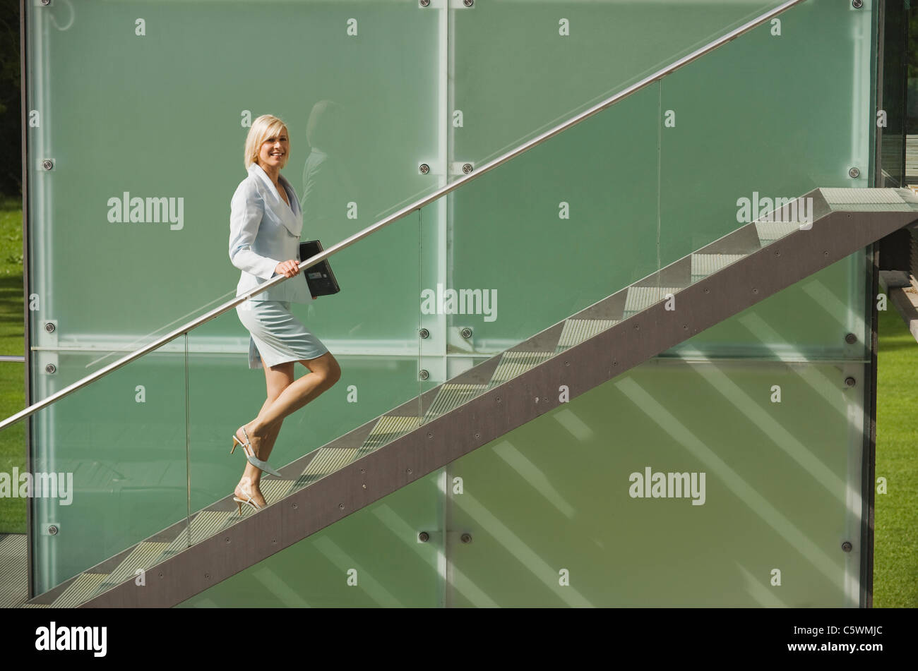 Mature woman climbing stairs hi-res stock photography and images - Alamy
