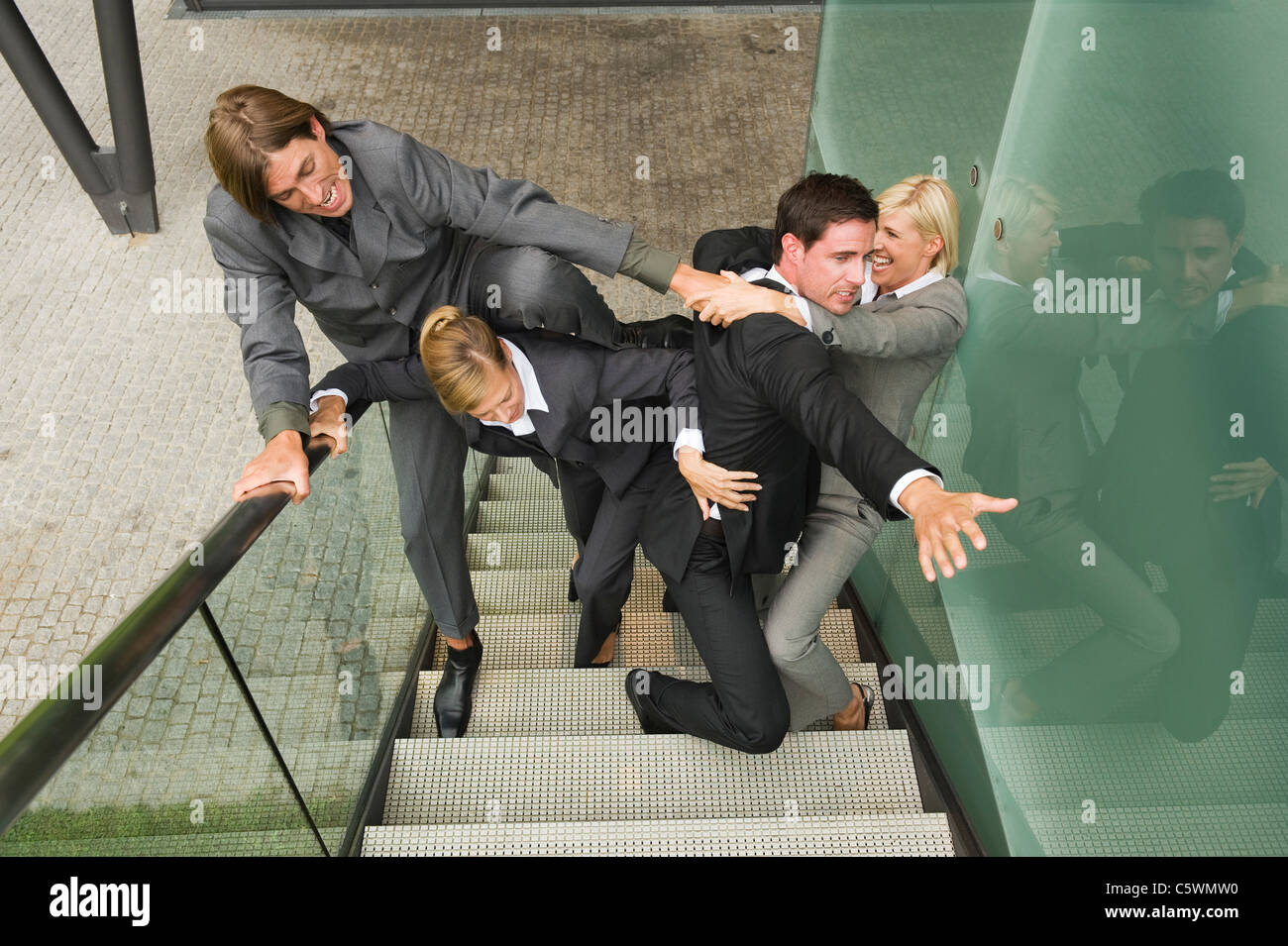 Business people fighting on staircase hi-res stock photography and ...