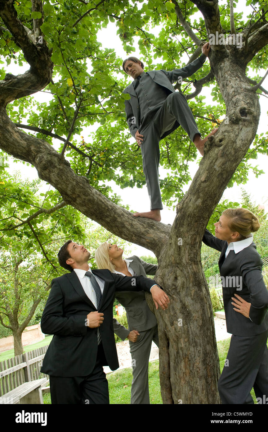 Germany, business people standing under tree, one man standing on ...
