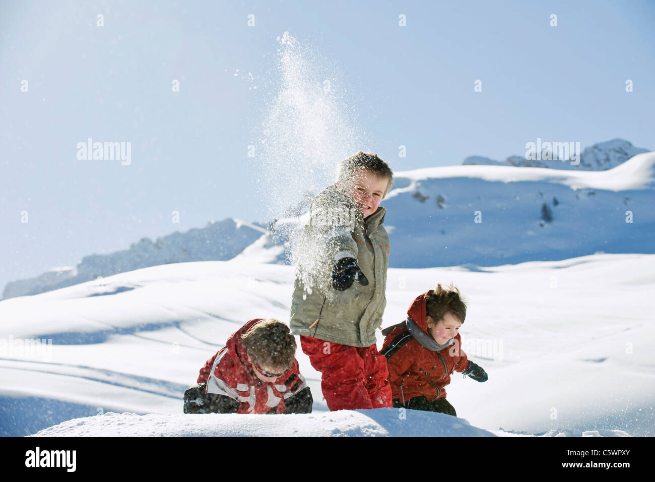 Boy throwing snow in air hi-res stock photography and images - Alamy