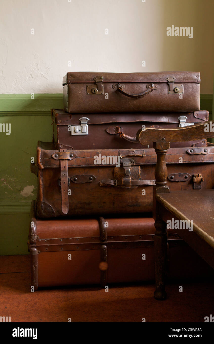 A pile of old leather suitcases and trunks in the railway waiting room ...