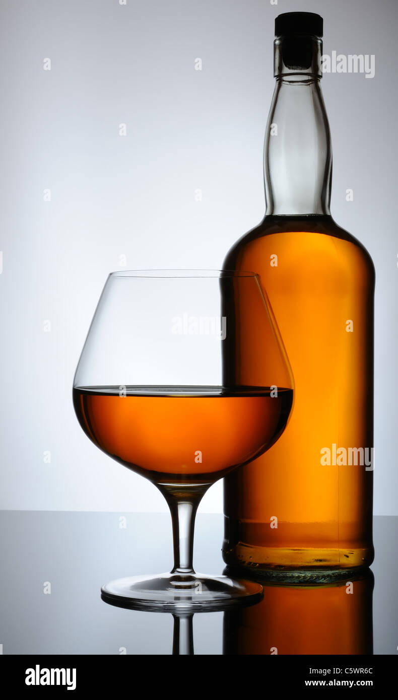 Studio shot of whiskey bottles and glasses Stock Photo - Alamy