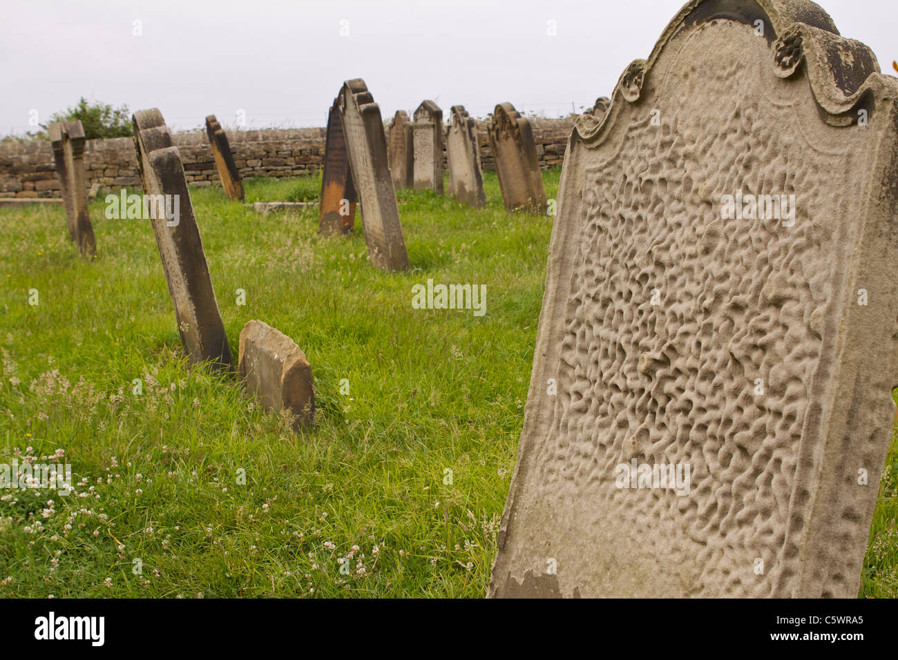 Eroded gravestones and tombs in the churchyard of St Mary's Church in ...