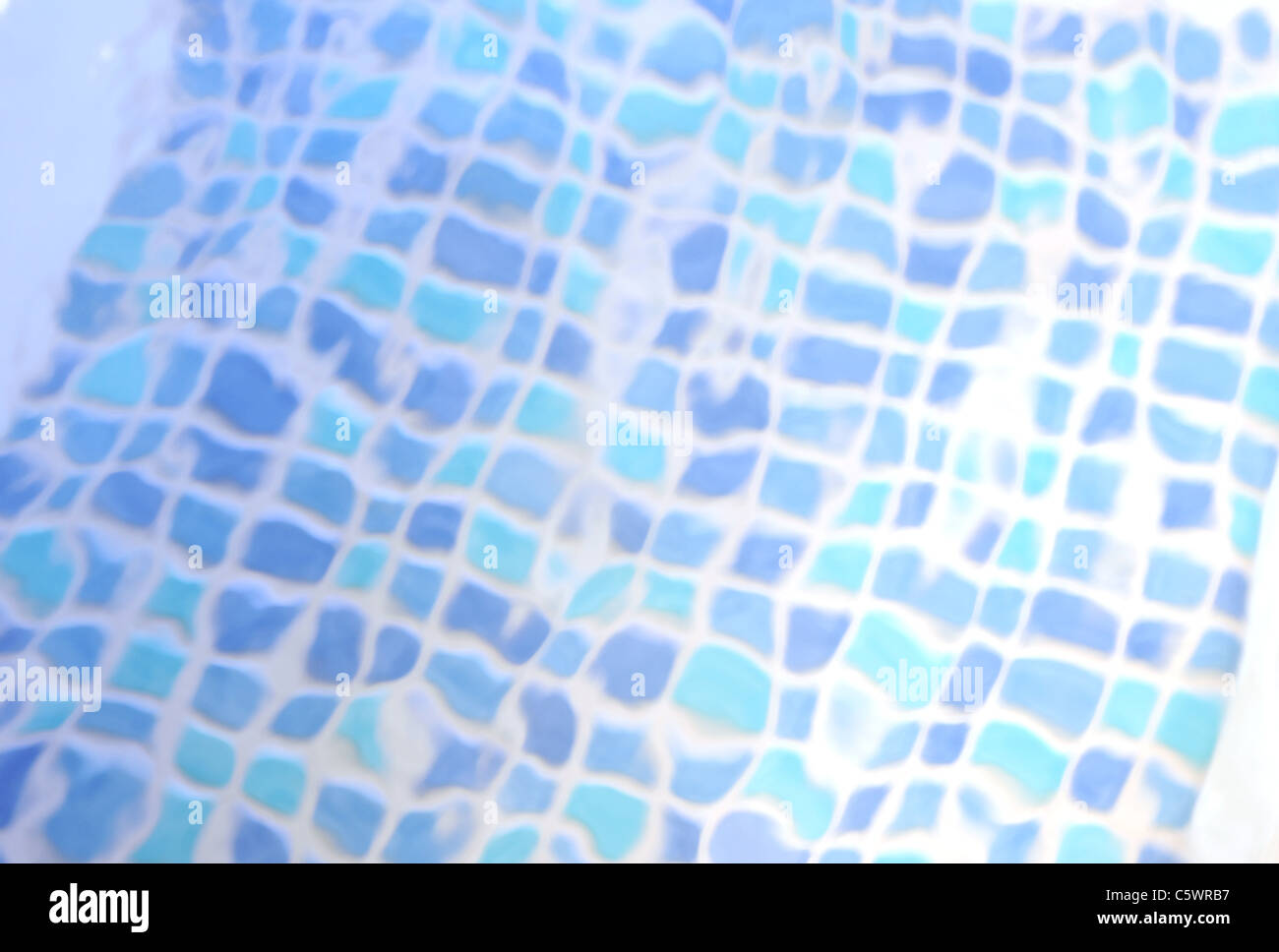 Swimming pool tiles through rippled water Stock Photo - Alamy