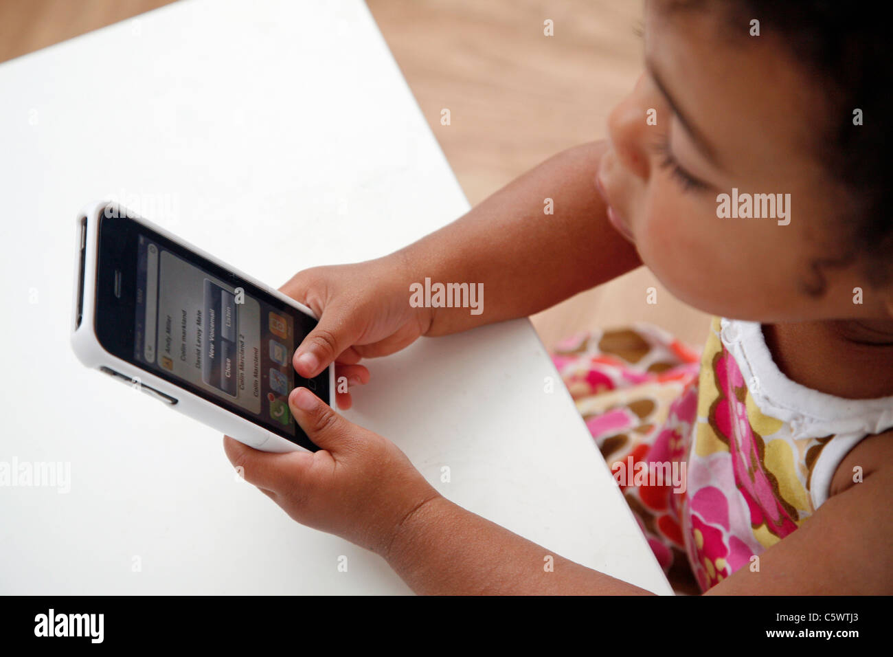 Toddler girl uses iphone Stock Photo - Alamy