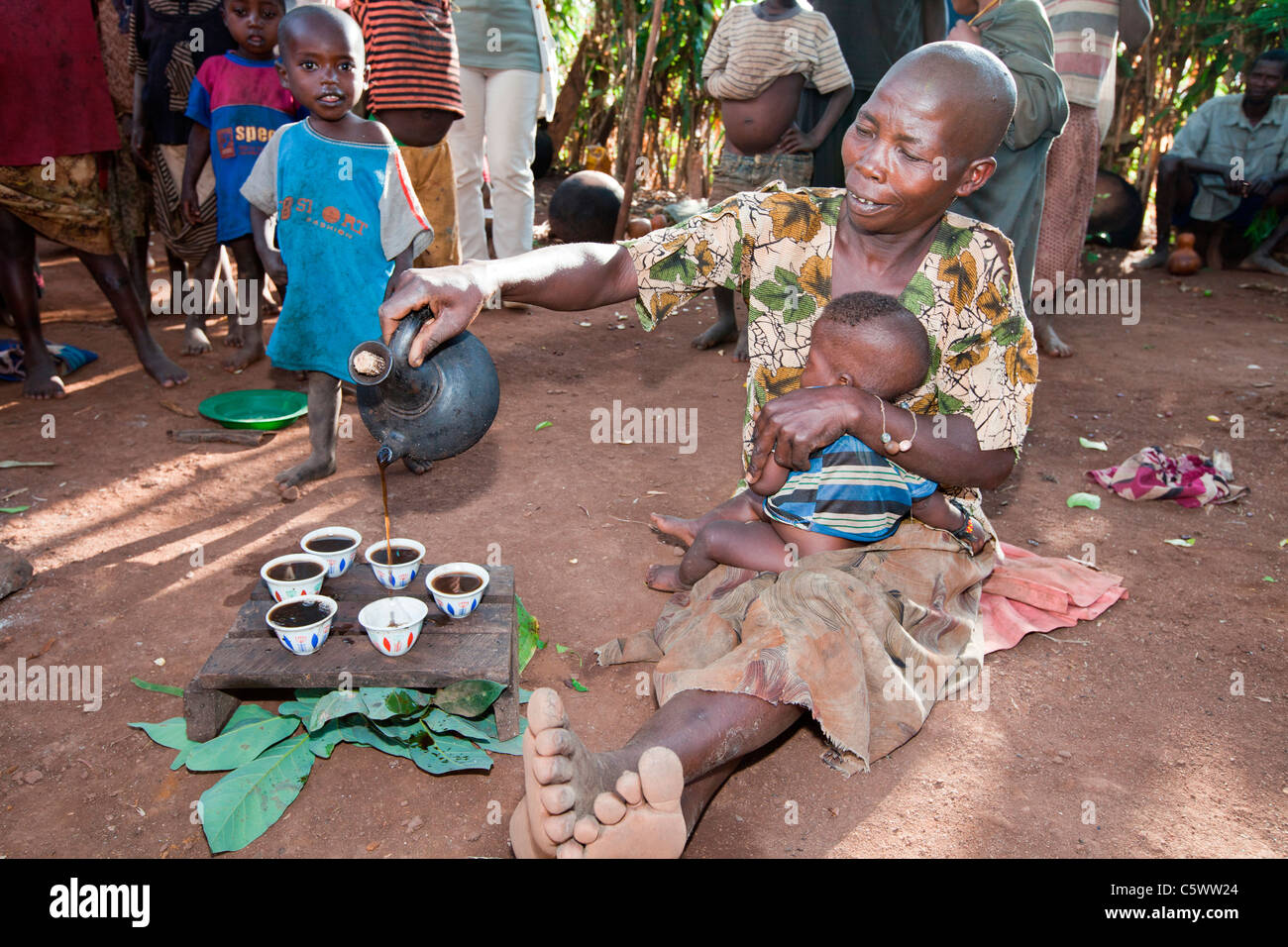 An Ari tribeswoman conducts a traditional Ethiopian coffee ceremony at ...