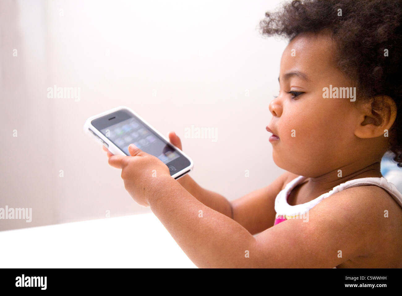 Toddler girl uses iphone Stock Photo - Alamy