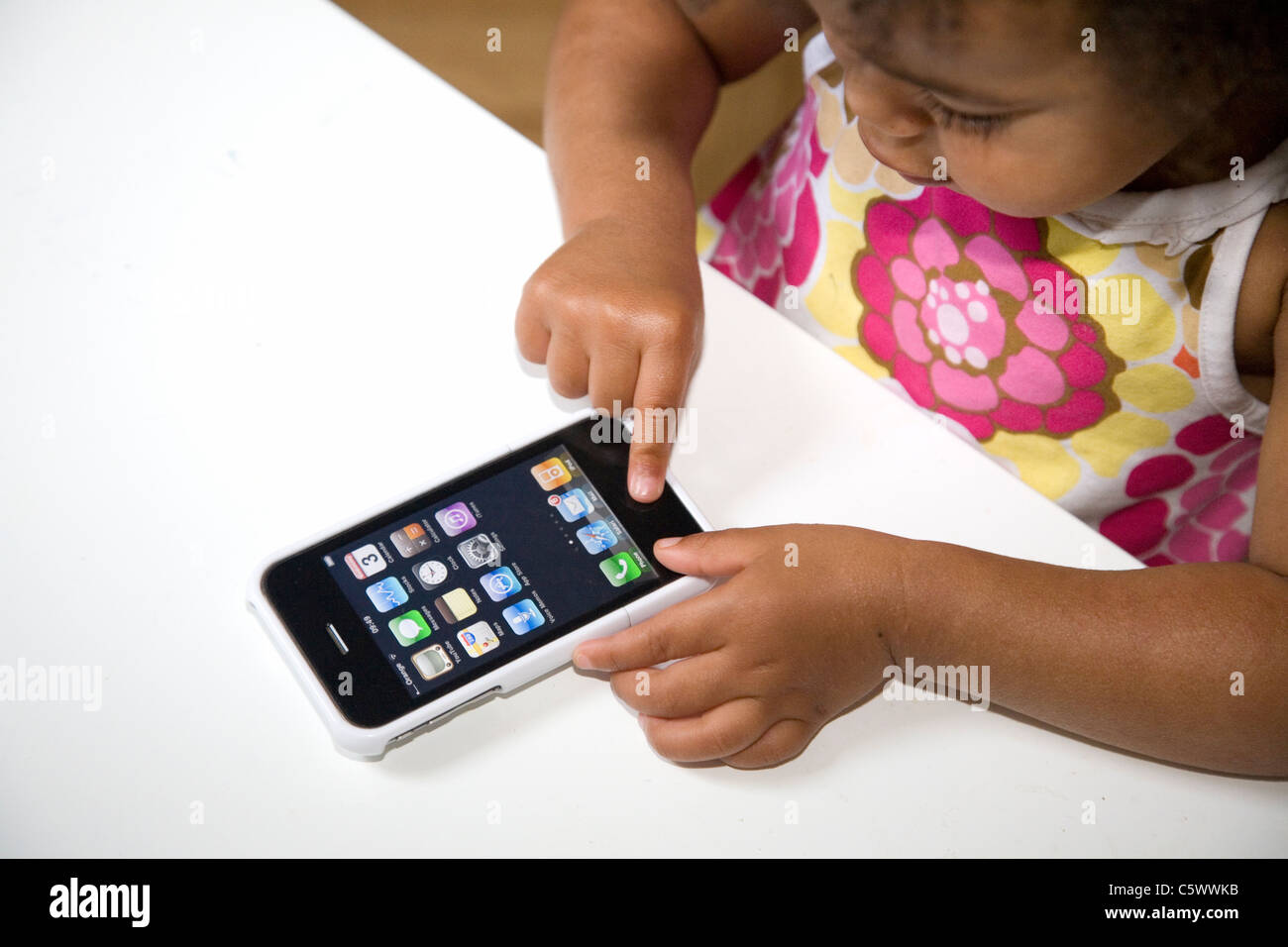 Toddler girl uses iphone Stock Photo - Alamy