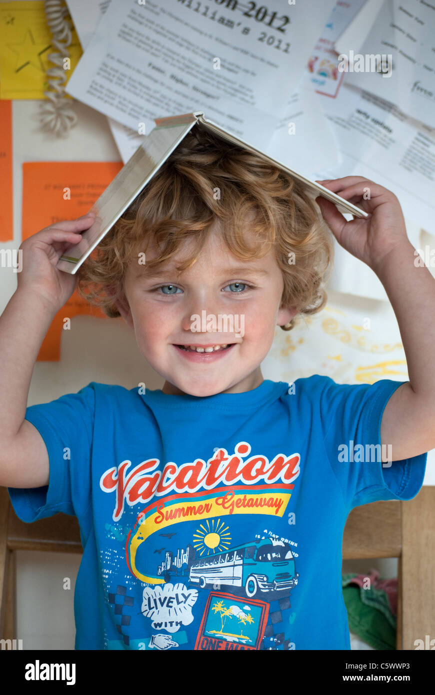 A child sitting with a book Stock Photo - Alamy