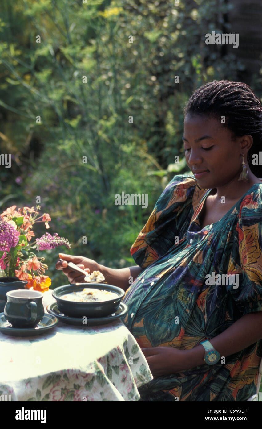 pregnant African woman eating healthy breakfast outside Stock Photo - Alamy