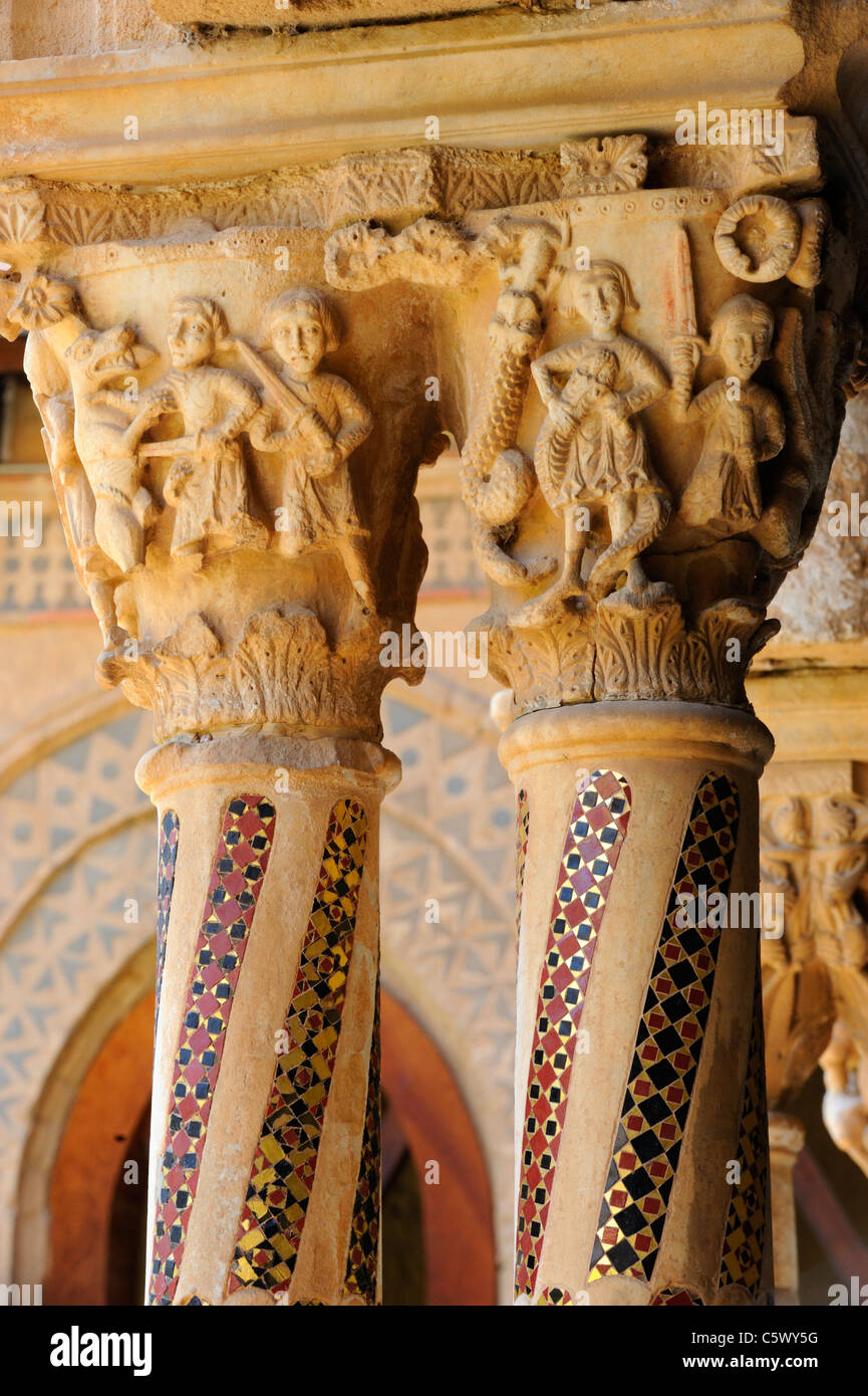 A pair of columns with richly guilded mosaic inserts topped with ...