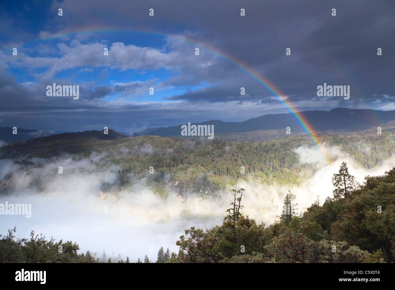 Rainbow over a valley in Yosemite National Park, California Stock Photo ...