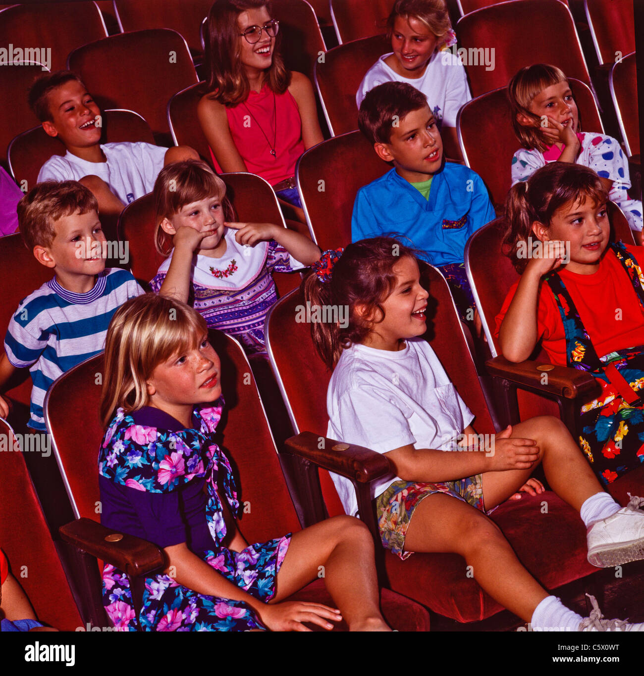 Group elementary school children enjoy theatrical performance in ...