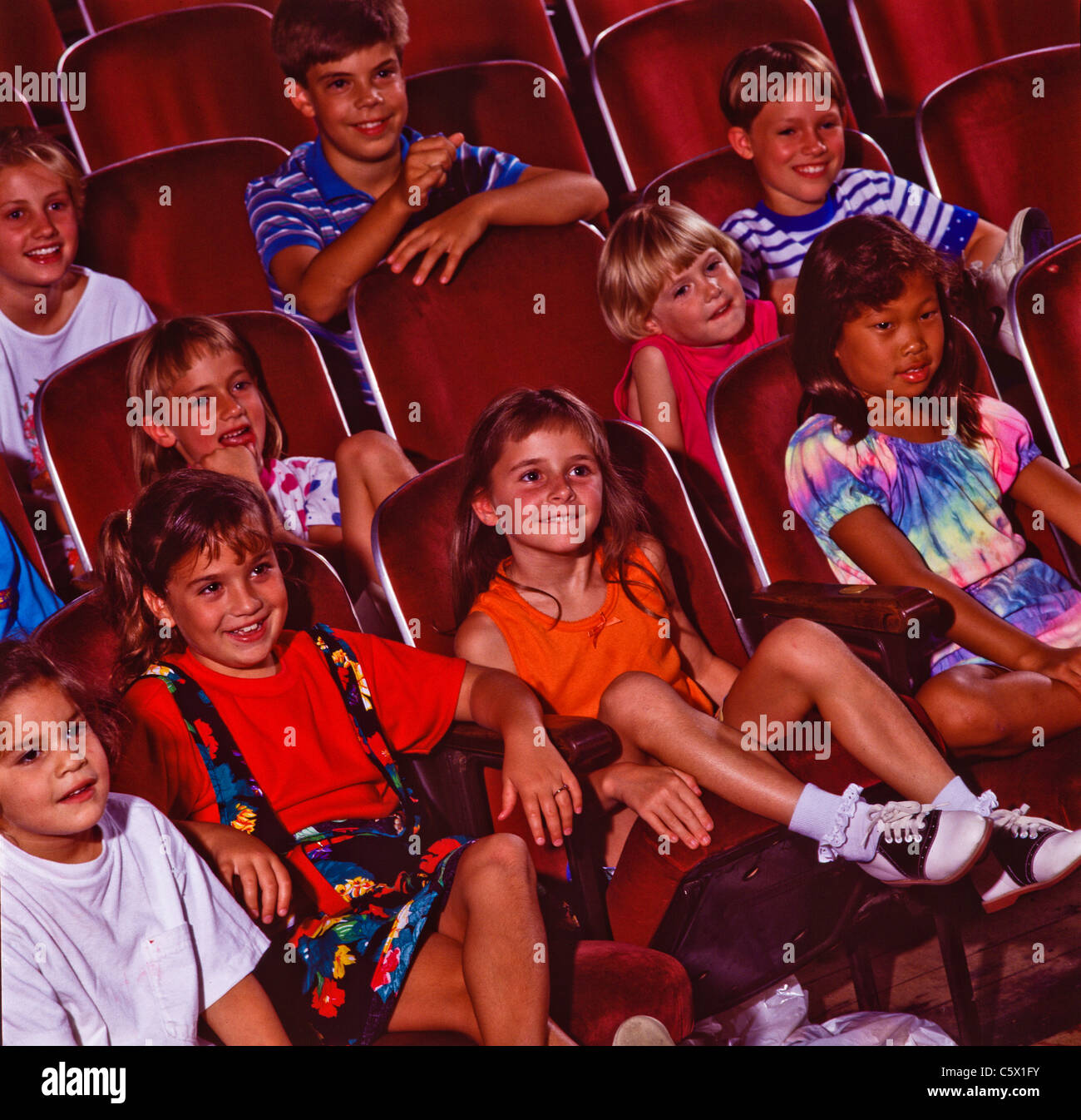 Group elementary school children enjoy theatrical performance in ...