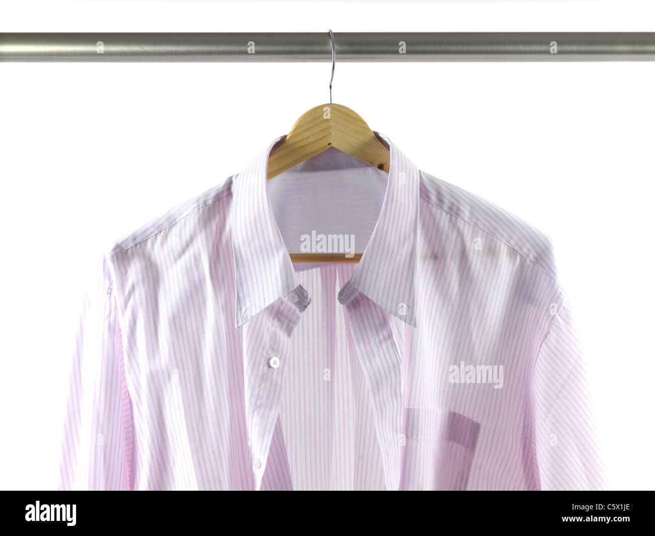 Garments hanging on coat hanger isolated against a white background ...