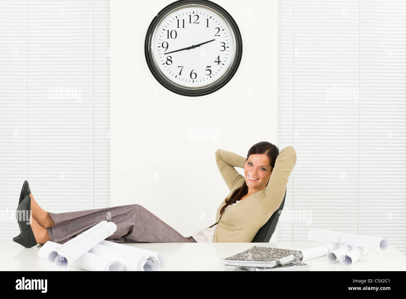 Office relaxation pose professional architect woman sitting behind ...