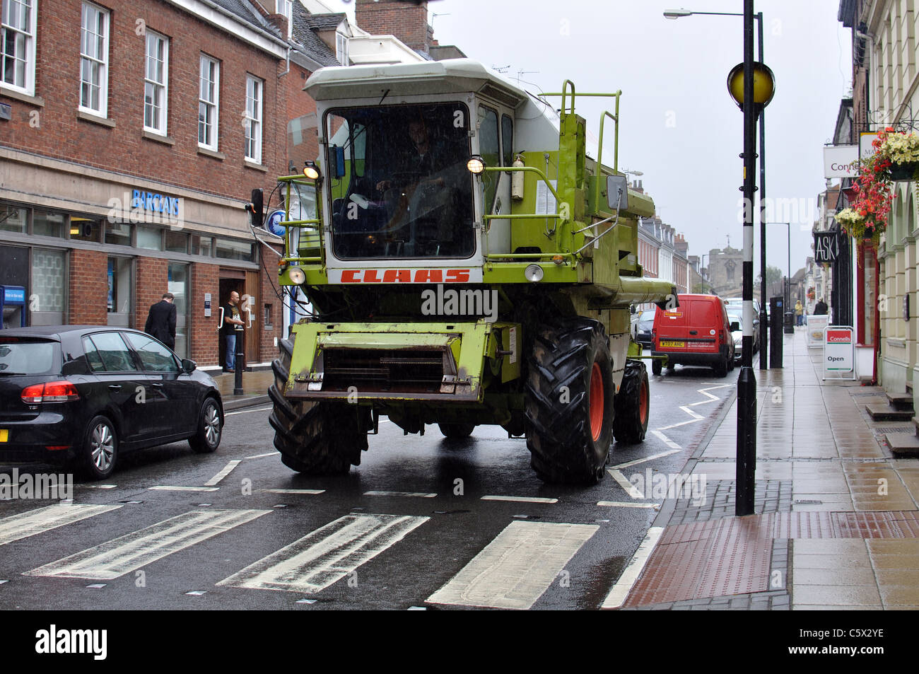 Combine harvester passing through town centre, Warwick, UK Stock Photo ...
