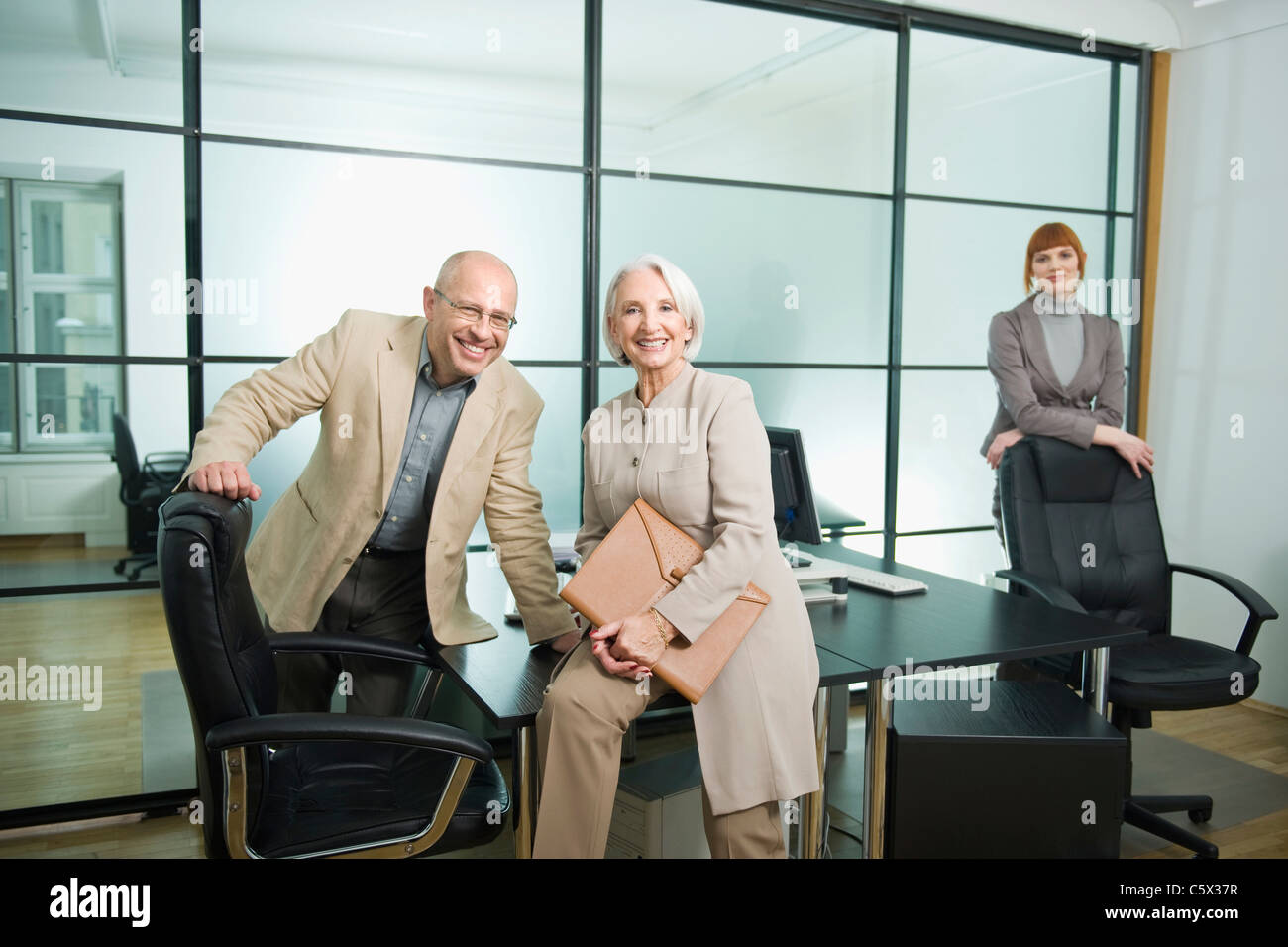 Germany, Munich, Business people in office, smiling, portrait Stock ...