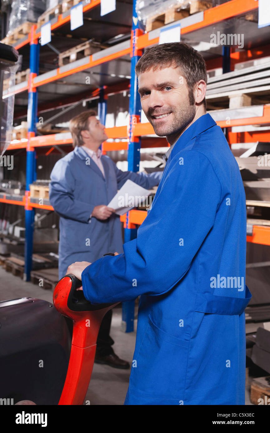 Germany, Neukirch, Foreman and apprentice in storeroom Stock Photo - Alamy