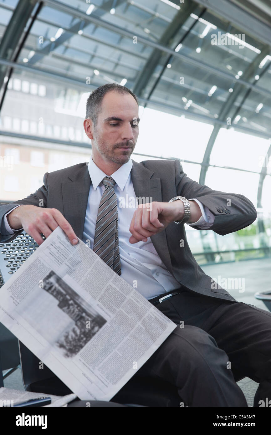 Germany, Leipzig, Businessman in Airport departure lounge, holding ...