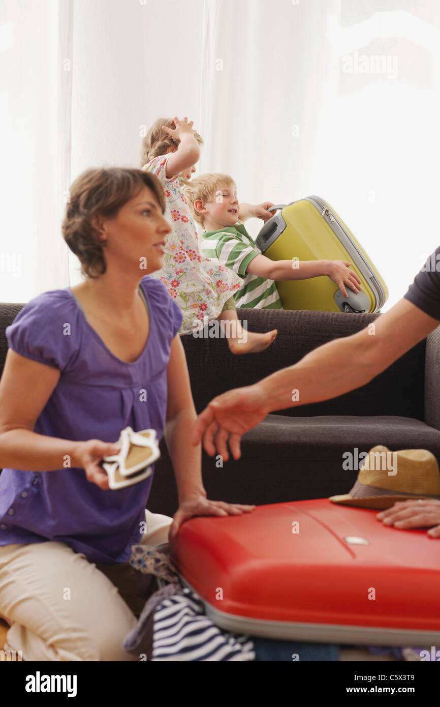 Germany, Leipzig, Family packing suitcase Stock Photo - Alamy