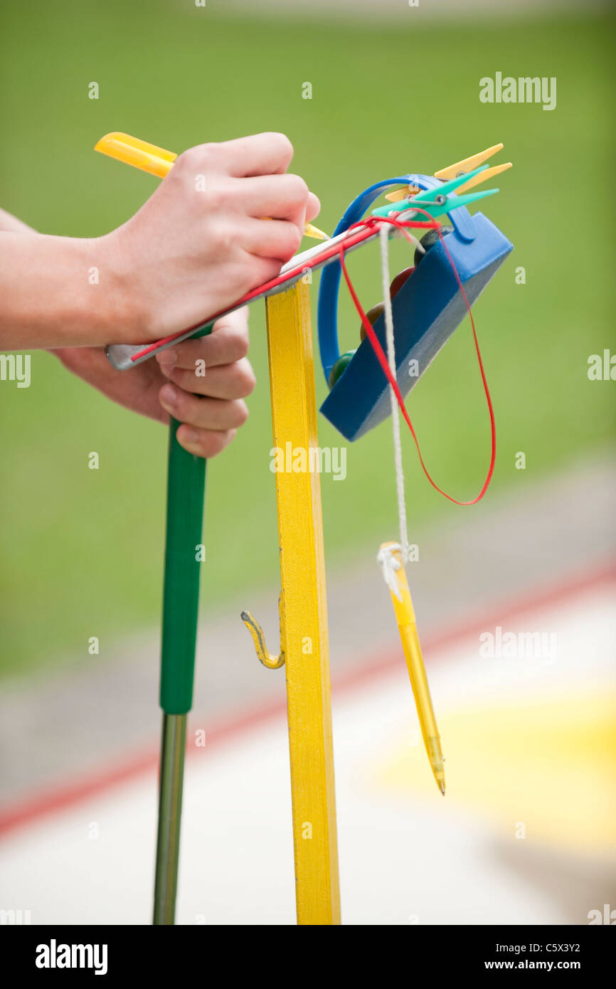Germany, Bavaria, Miniature golf, Person writing on score card, close ...