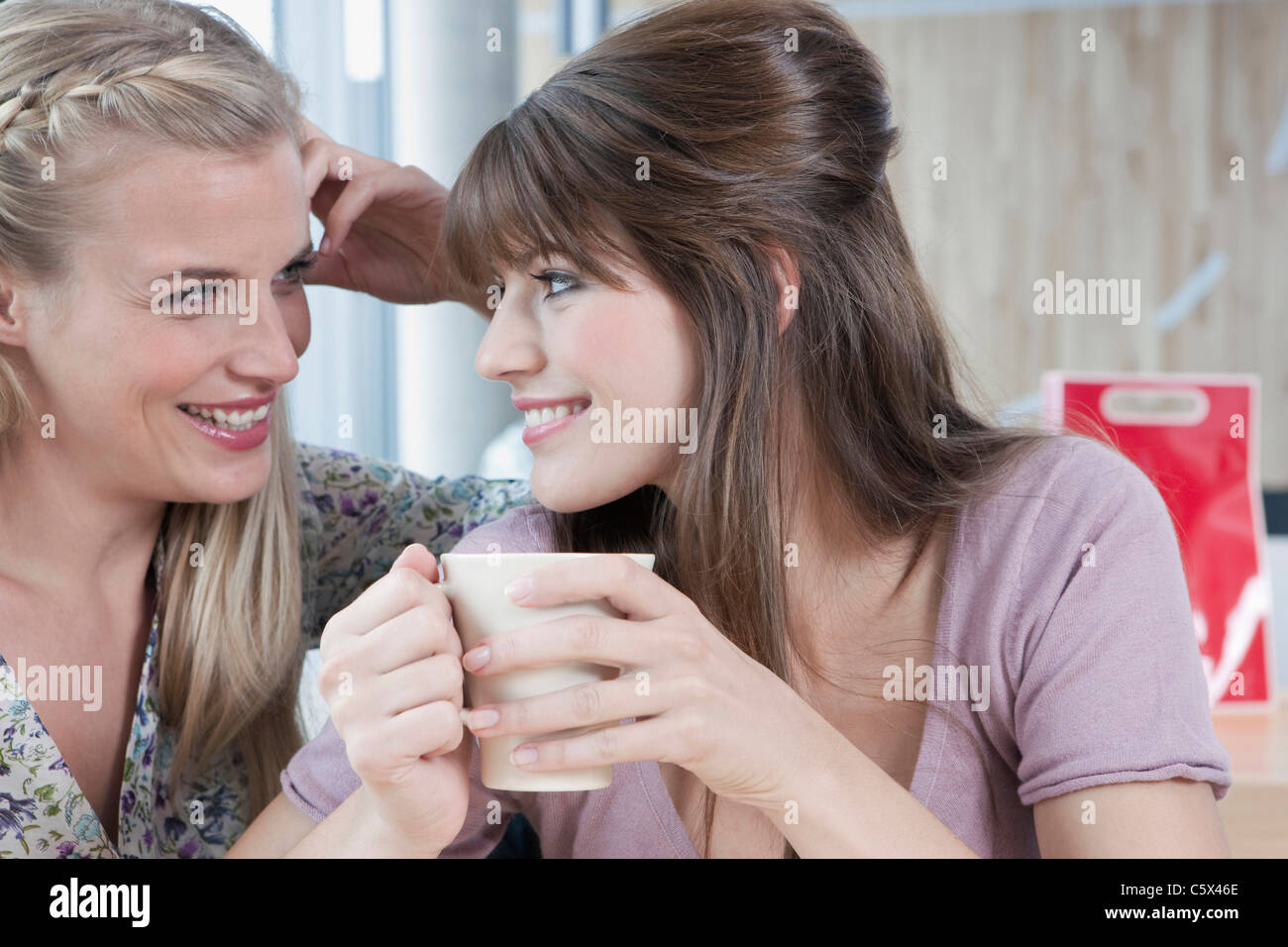 Germany, Cologne, Young women in cafe Stock Photo - Alamy