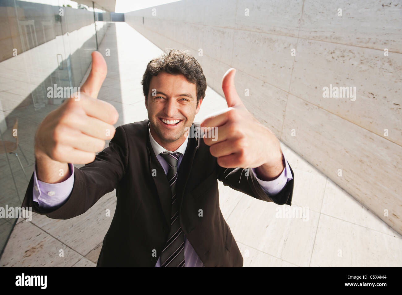 Spain, Mallorca, Businessman, thumbs up, laughing, portrait Stock Photo ...