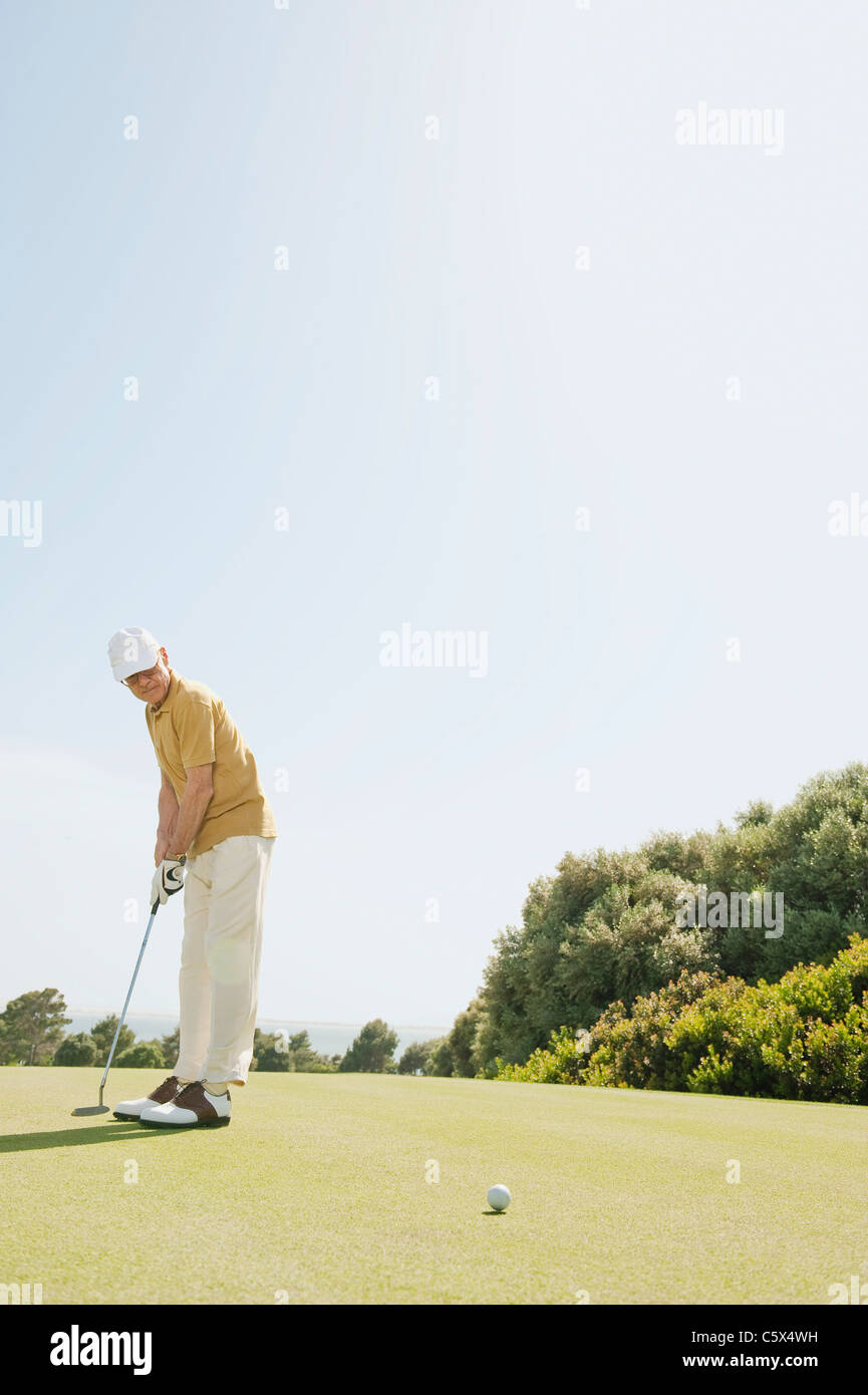 Spain, Mallorca, Senior man playing golf, side view Stock Photo - Alamy